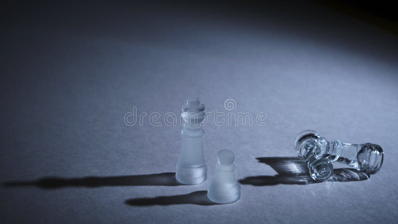 Side View of Crystal Chess King and Pawn in Front of Defeated Enemies ...
