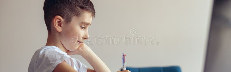Side View of Cute Little Boy Pupil with Braces Writing Exercise in ...
