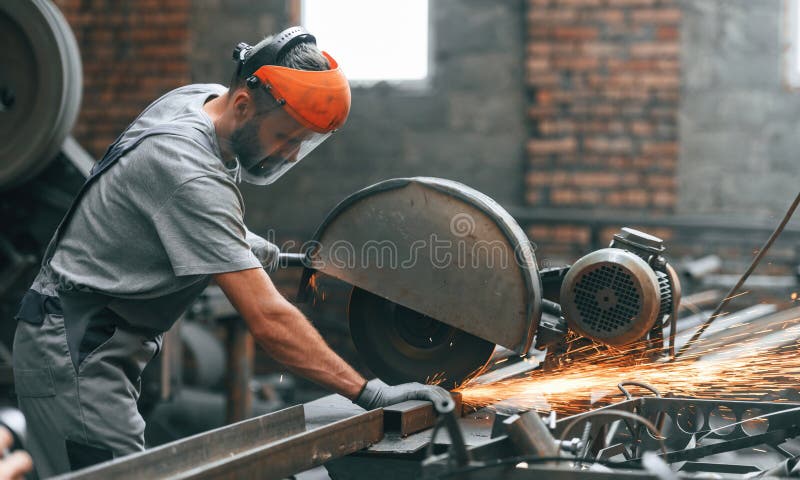 Side View, Cutting the Metal. Young Factory Worker in Grey Uniform ...