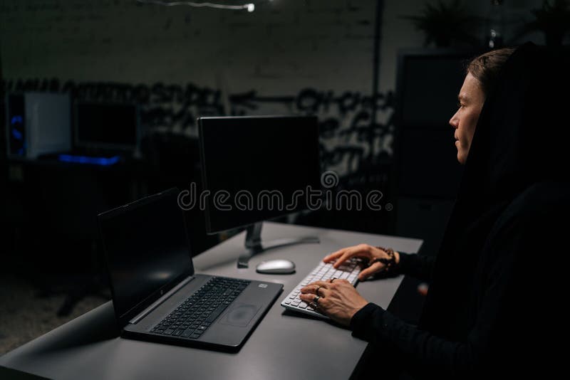 Side View Of Dangerous Hacker Man Wearing Hooded Typing On Wireless