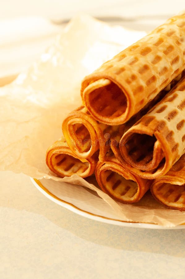 Rolled Waffles in Stack on Parchment Paper and White Plate at Home ...