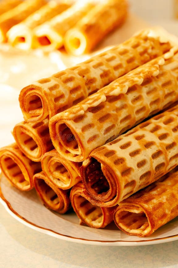 Rolled Waffles in Stack on Parchment Paper and White Plate at Home ...