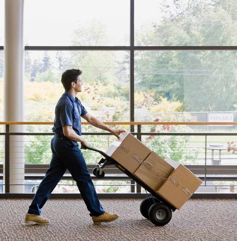 Side View of Delivery Man Ipushing Stack of Boxes Stock Image - Image ...