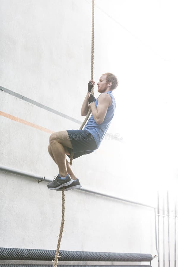 Side View of Determined Man Climbing Rope in Crossfit Gym Stock Image ...