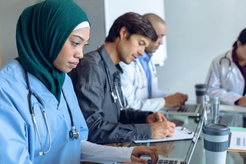 Medical Team Working Together at Table in Hospital Stock Image - Image ...