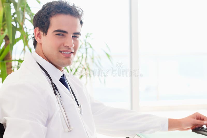 Side View of Doctor Sitting Behind His Desk Stock Image - Image of ...