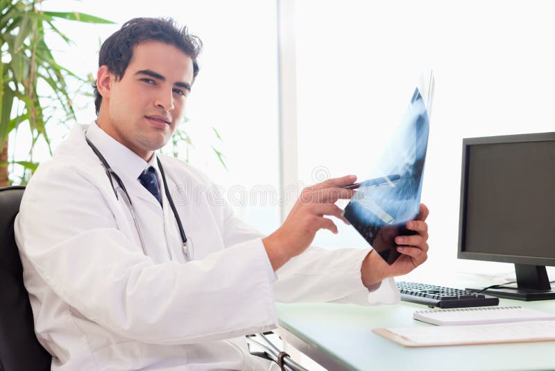 Side View of Doctor Sitting in His Office with an X-ray Stock Image ...