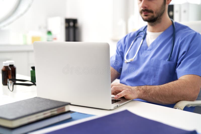 Side View of Doctor while Working on the Computer Stock Photo - Image ...