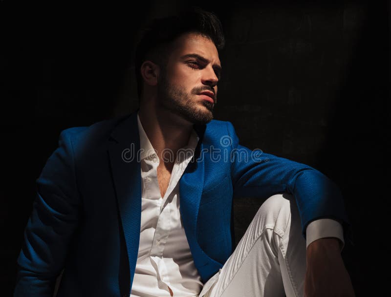 Side View of a Dramatic Man Sitting in Studio Stock Photo - Image of ...