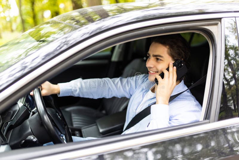 Side View of Elegant Driver Talking on Mobile Phone and Watching for ...