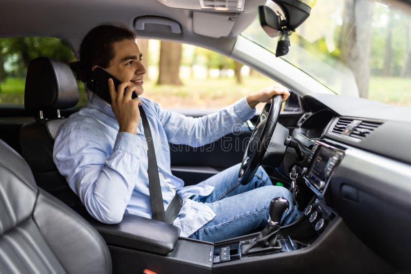 Side View of Elegant Driver Talking on Mobile Phone and Watching for ...