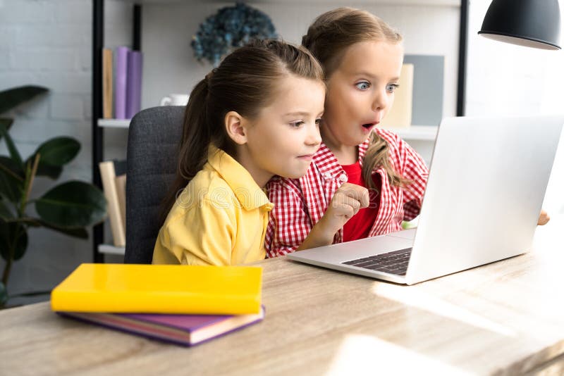 Side View of Emotional Little Kids Using Laptop at Table Stock Photo ...