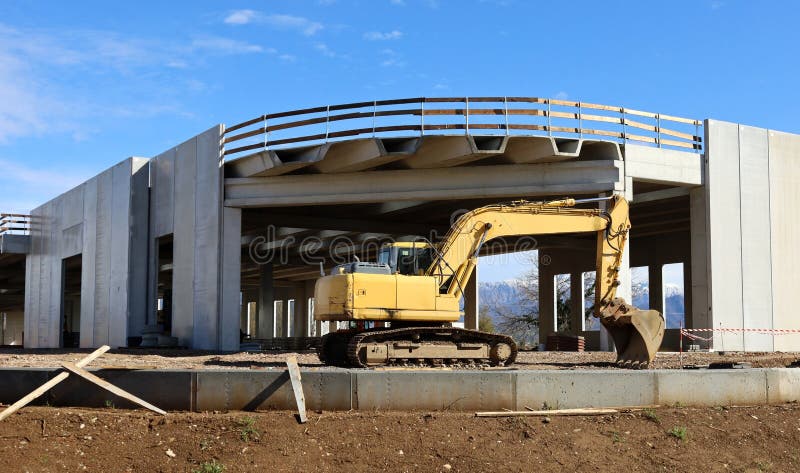 Excavator in Front of New Commercial Building Under Construction Made ...