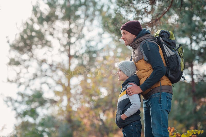 Side View of Father with Backpack and Cute Little Son Looking Away ...