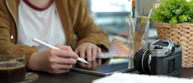 Side View of Female Designer Working with Digital Tablet on Black Table ...