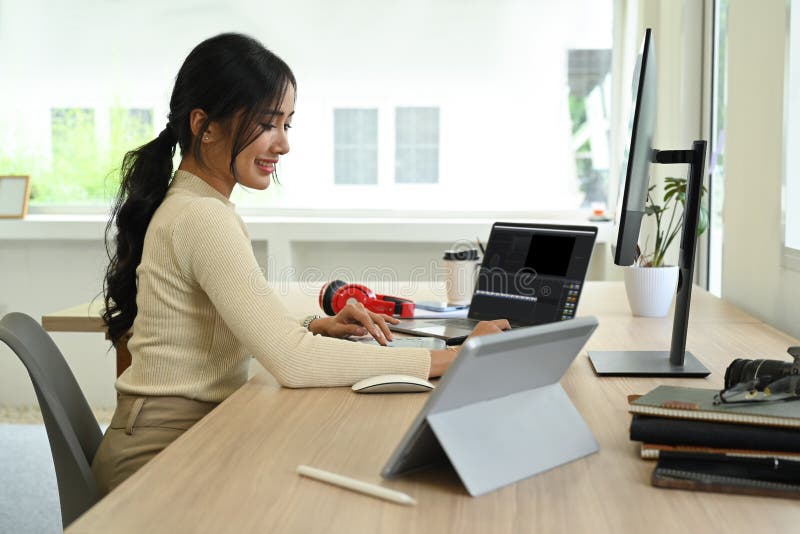 Side View of Female Freelancer Editing Video and Audio Footage with ...