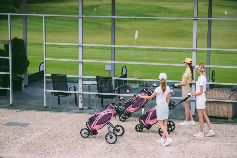 Side View of Female Golfers with Golf Gear Walking at Golf Course Stock ...