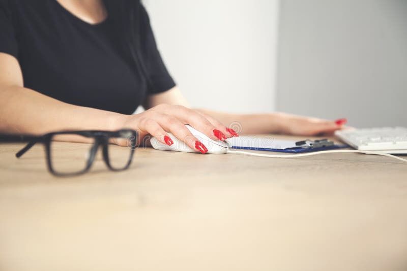 Side View of Female Hands Using Computer on Table with Glasses and ...