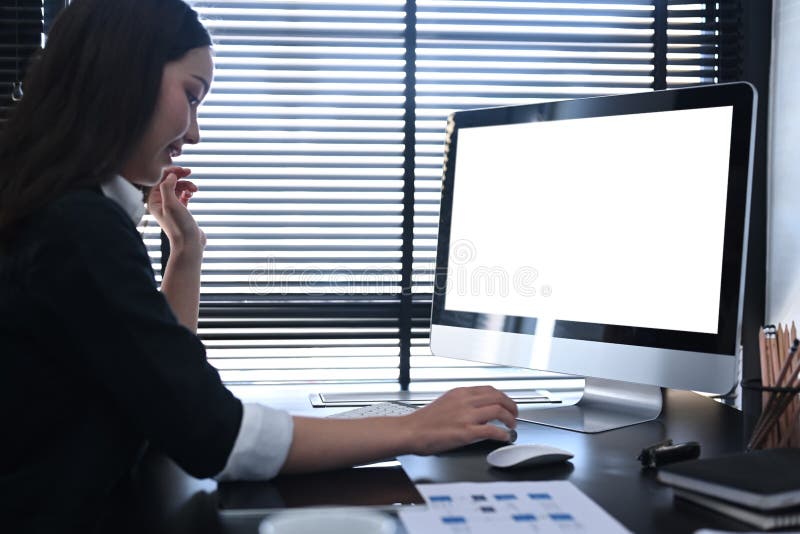 Side View of Female Office Worker in Black Suit Working on Computer and ...