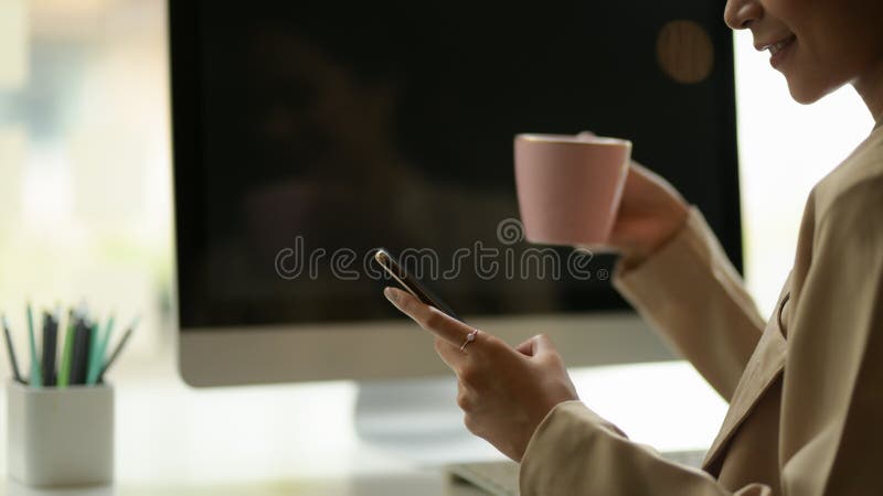 Side View of Female Office Worker Take Some Rest with Smartphone and a ...