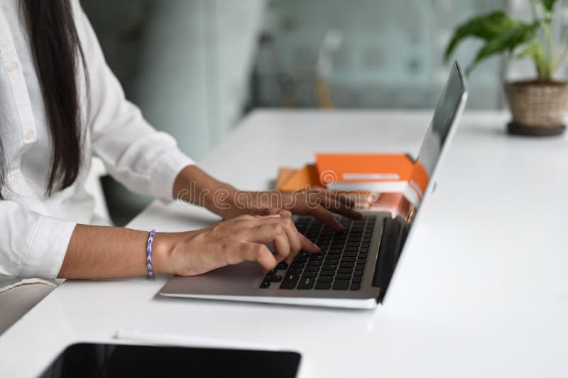 Side View of Female Office Worker Working on Laptop at Office. Stock ...
