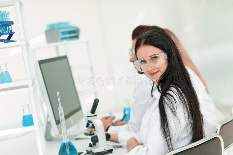 Side View.female Scientist Sitting at a Lab Table Stock Photo - Image ...