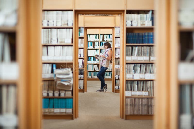 Side View of a Female Student Reading a Book in Library Stock Image ...