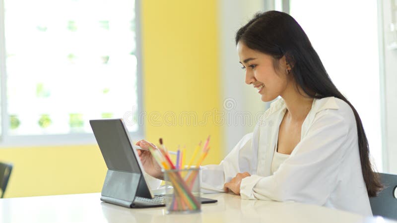 Female Student Using Digital Tablet while Studying in Classroom Stock ...