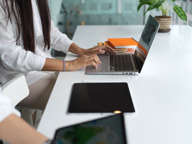 Side View of Female Students Doing Homework with Digital Devices on ...