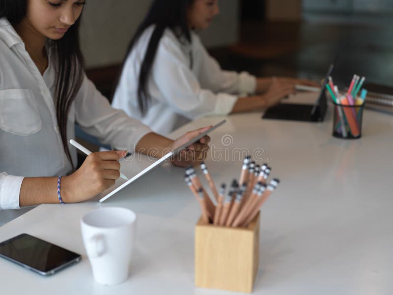 Female University Students Doing Assignment with Digital Devices and ...