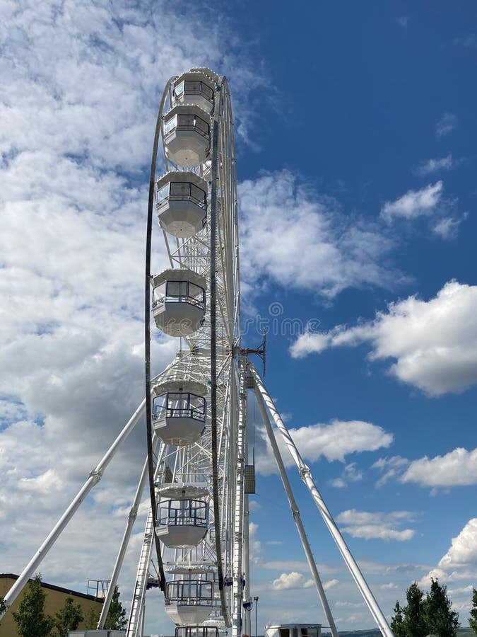 Side View of a Ferris Wheel in a Blue Cloudy Sky Stock Photo - Image of ...