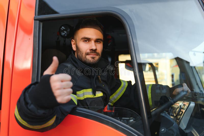 Side View of Firefighter in Protective Uniform Driving Fire Engine ...