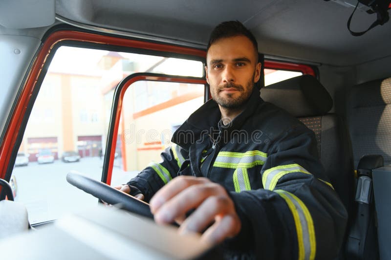 Side View of Firefighter in Protective Uniform Driving Fire Engine ...