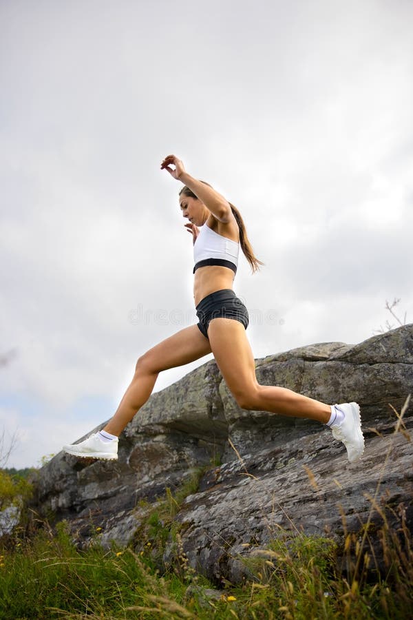 Side View of Fitness Woman Doing High-intensity Running on Mountainside ... Side View of Fitness Woman Doing High-intensity Running on Mountainside ...