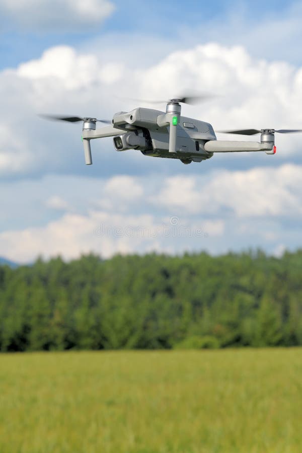 Side View of a Flying Modern UAV Drone on Yellow Corn Field a Blue Sky ...