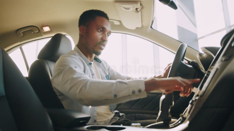 Side View of Focused African Man Sitting on Driver S Seat and Using ...