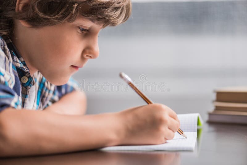 Kid writing in copybook stock photo. Image of knowledge - 103862022