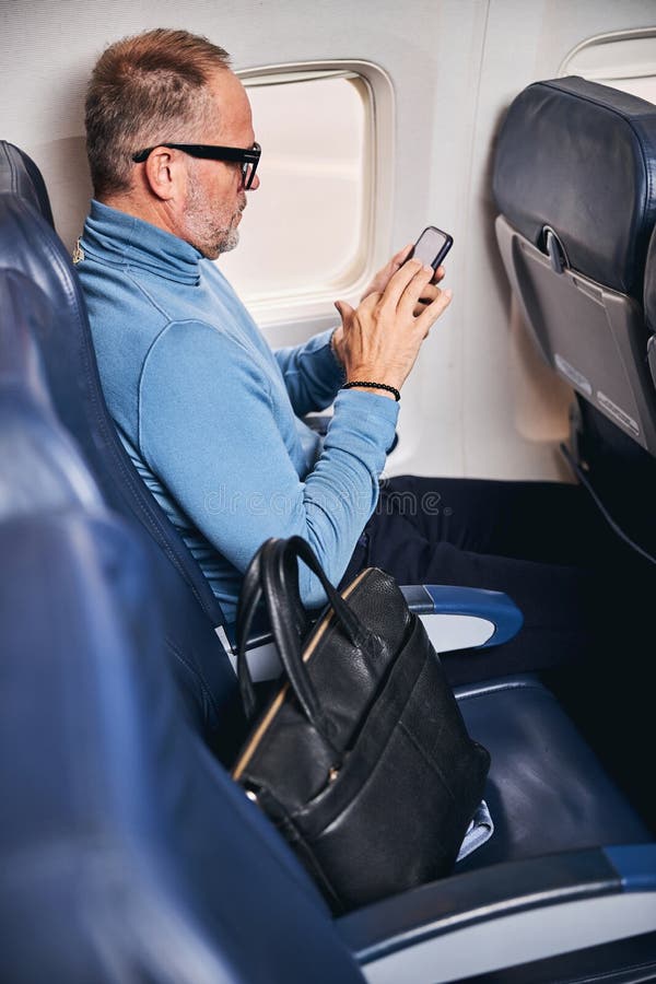 Airplane Passenger in a Jumper Texting on the Cellphone Stock Image ...