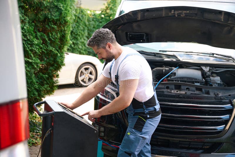 Experienced Auto Technician is Servicing Client Car Air Conditioning ...
