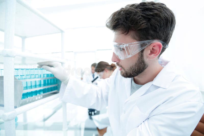 Side View of Focused Scientist Holding Test Tube in Laboratory Stock ...