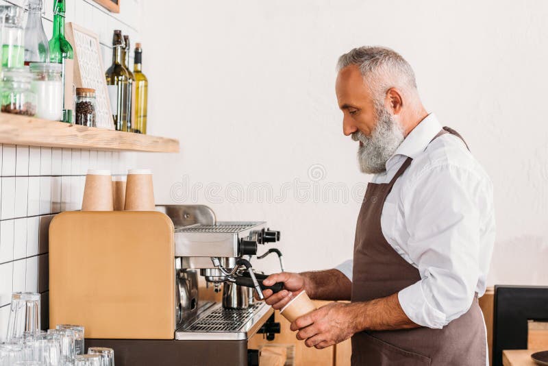 Side View of Focused Senior Barista Using Coffee Machine while Stock ...