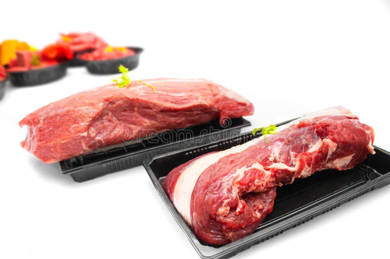 Side View of Fresh Beef Cuts in Black Trays with Background Ingredients ...