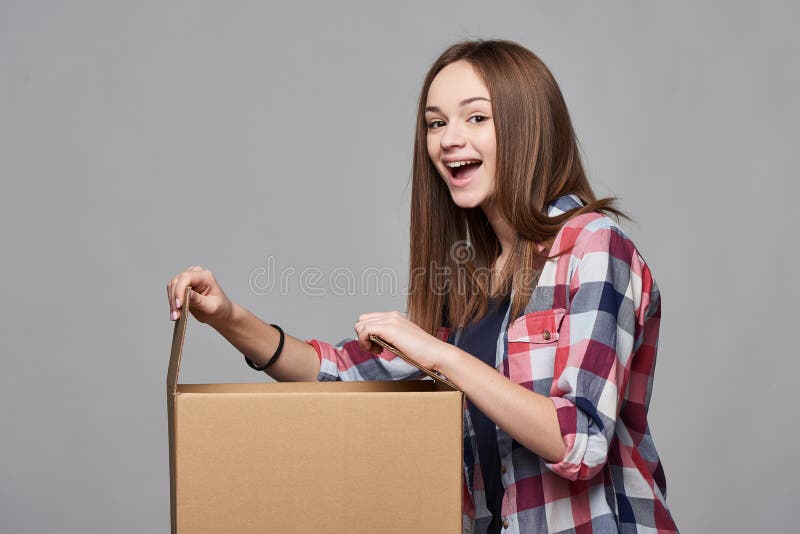 Girl Opening a Carton Box and Looking Inside Stock Image - Image of ...