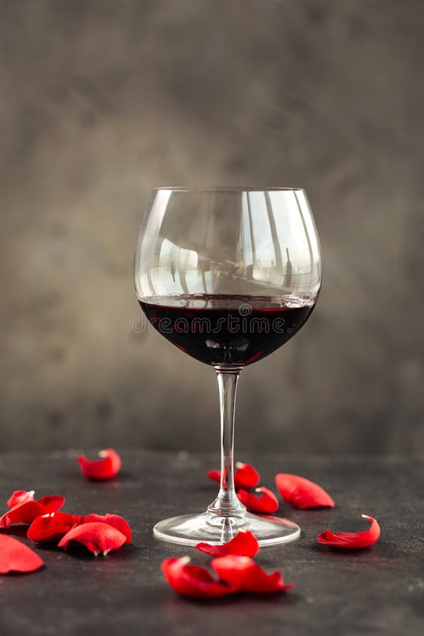 Side View on a Glass of Red Wine with Petals Stock Photo - Image of ...
