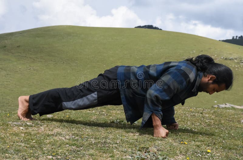 Side View of a Good Looking Indian Young Man Doing Fist Push-ups in the ...