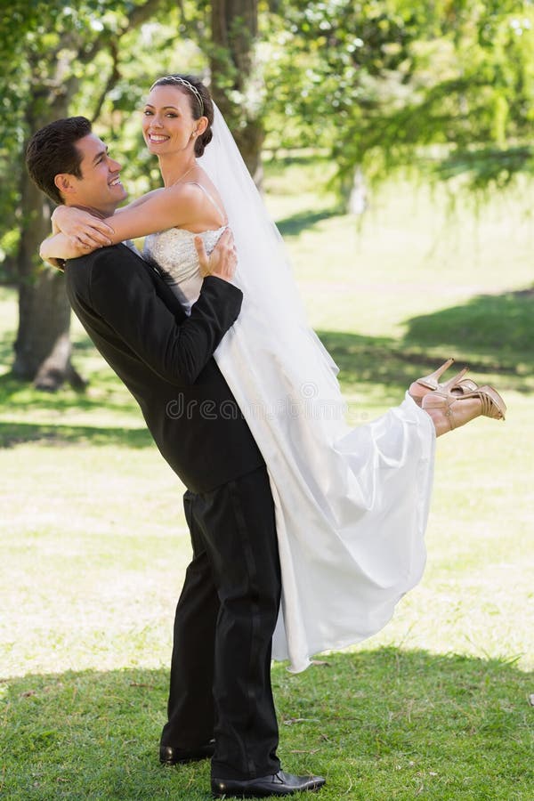 Side View Groom Lifting Bride in Garden Stock Photo - Image of people ...