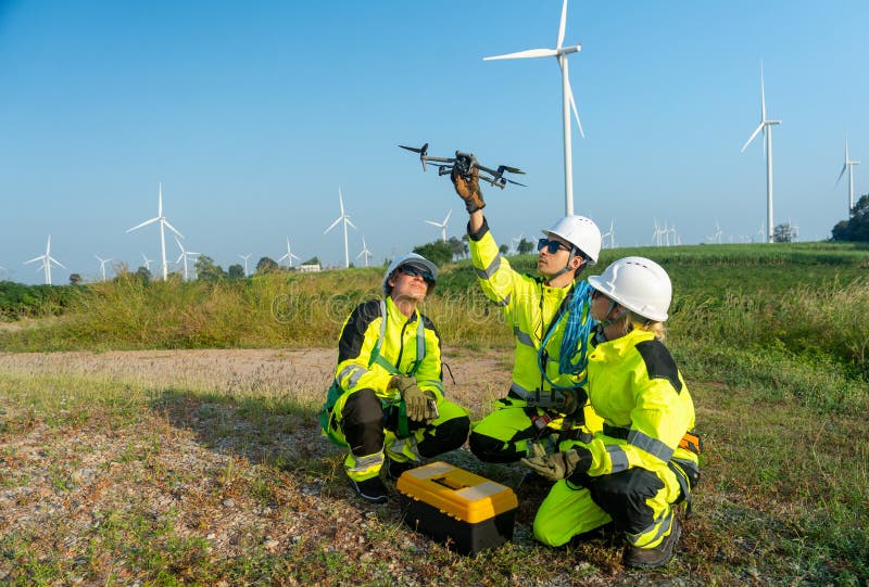 Side View Group of Wind Turbine or Windmill Workers or Technician Check ...