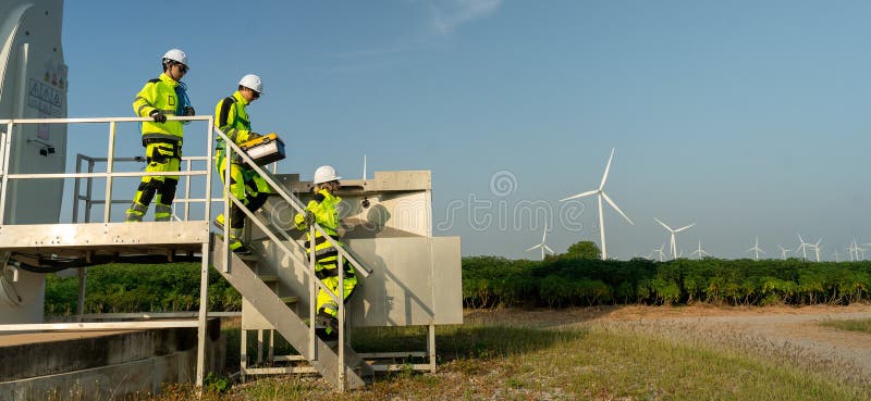 Side View Group of Wind Turbine or Windmill Workers or Technician Walk ...