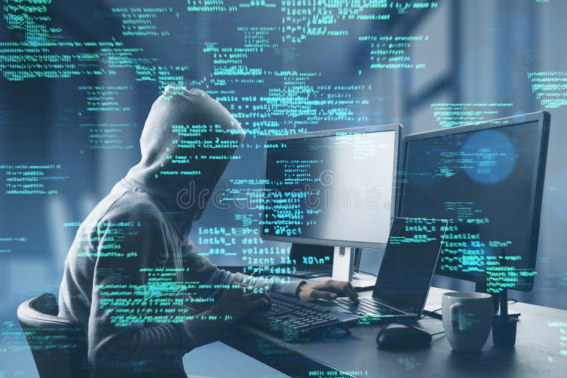 Hacker at Desk Using Computers with Creative Glowing Blue Map Hologram with Chart and Grid on ...