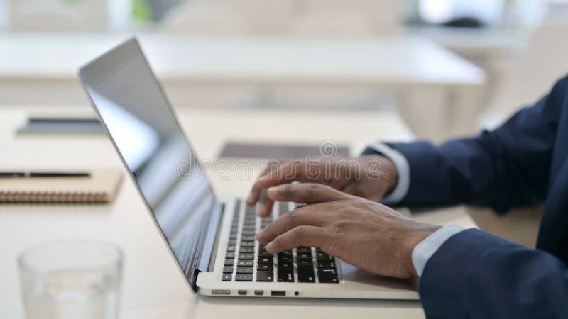 Side View of Hands of African Businessman Typing on Laptop, Close Up ...